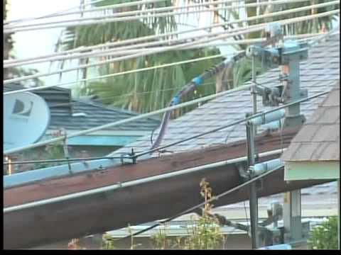Fallen power poles damage several homes - YouTube