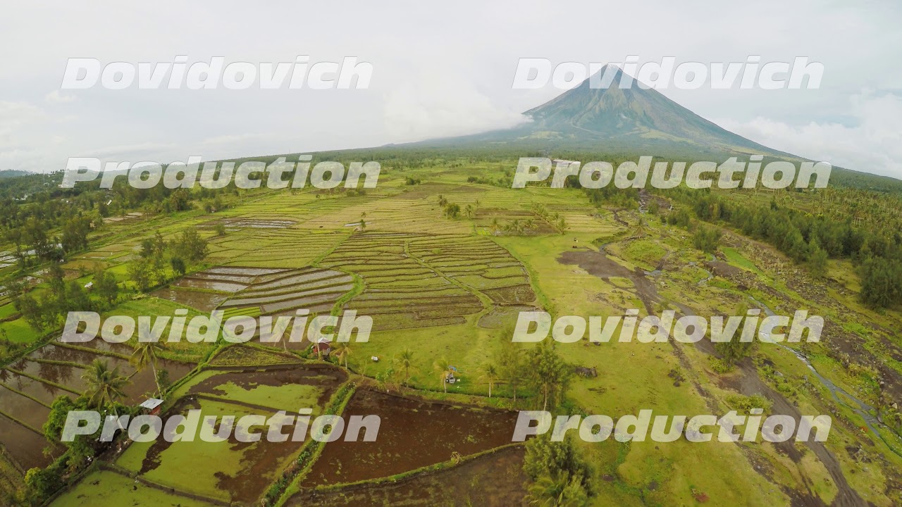 Mayon Volcano near Legazpi city in Philippines. Aerial view over rice ...