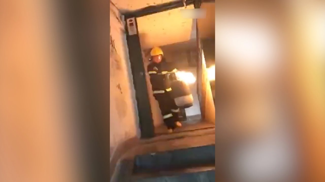 Firefighter grabs burning gas cylinder from house, warning people to ...