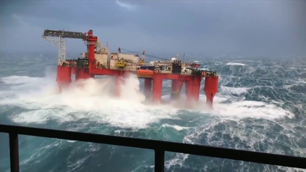 Huge waves crash against swaying North Sea oil rig - YouTube