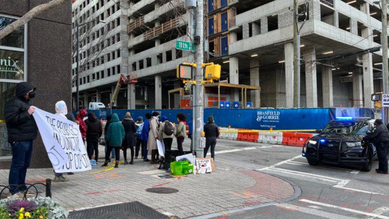 Activists lock themselves to equipment in Midtown Atlanta - YouTube