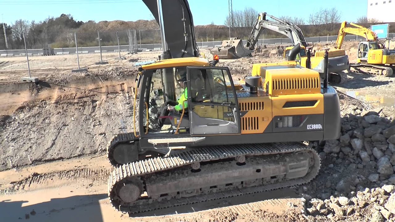 Volvo EC 380 DL loading Scania trucks at a roundabout construction ...