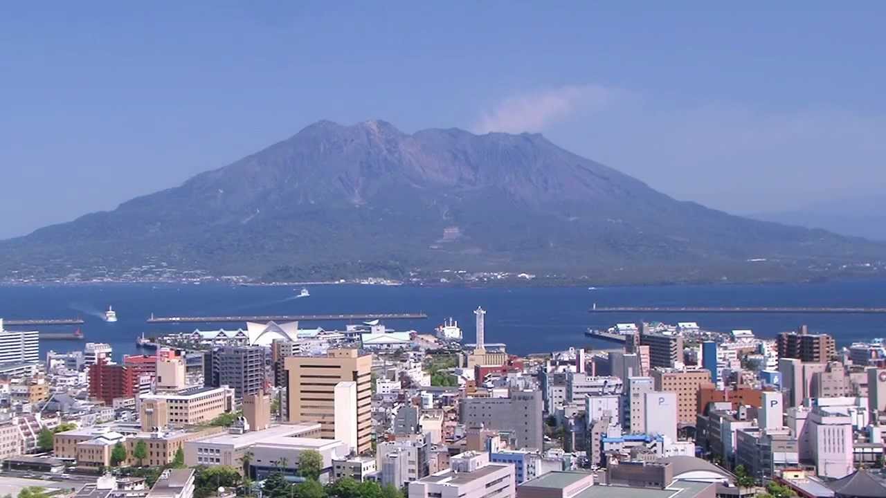 Aerial view of Kagoshima city and Sakurajima active volcano. Timelapse ...