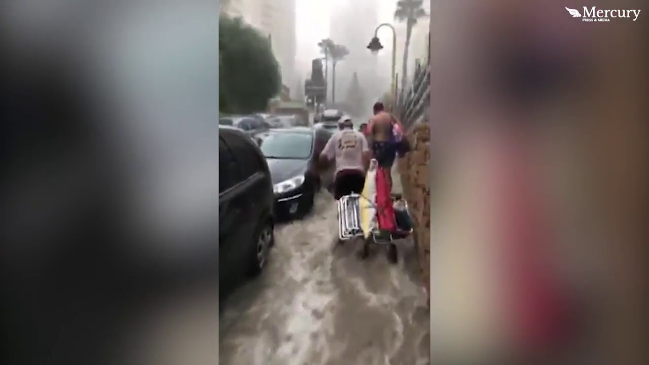 Benidorm tourists flee beach after flash floods turn resort's streets ...
