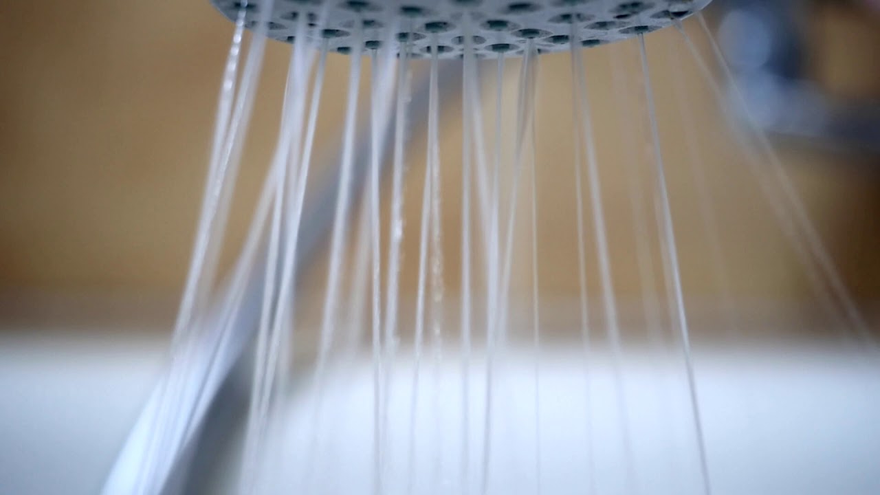 Water sprays out of a shower head in slow motion. Free HD video footage ...