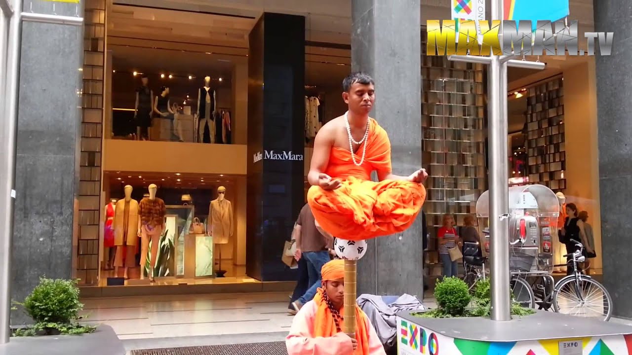 Monk balancing another monk on a football - YouTube