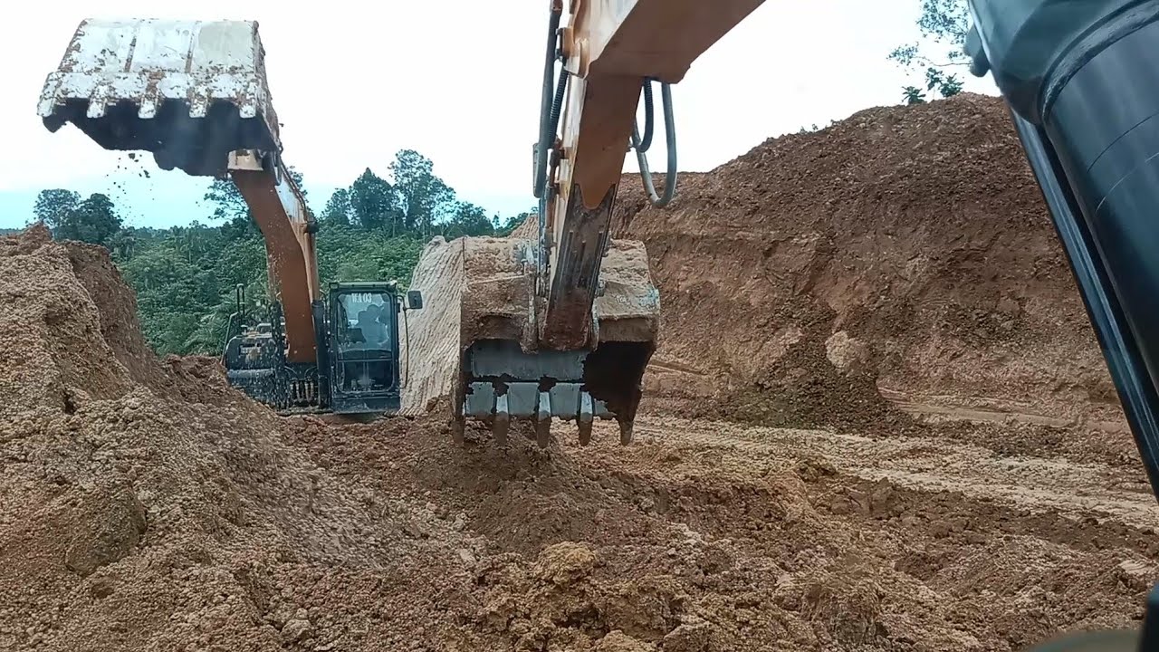 Excavators do the job of digging up the battered earth for disposal ...