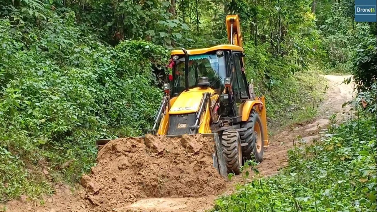 JCB Backhoe Loader-Leveling TOP SOIL of UPs and DOWNs Narrow Road - YouTube