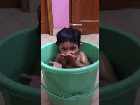 Taking a bucket bath...