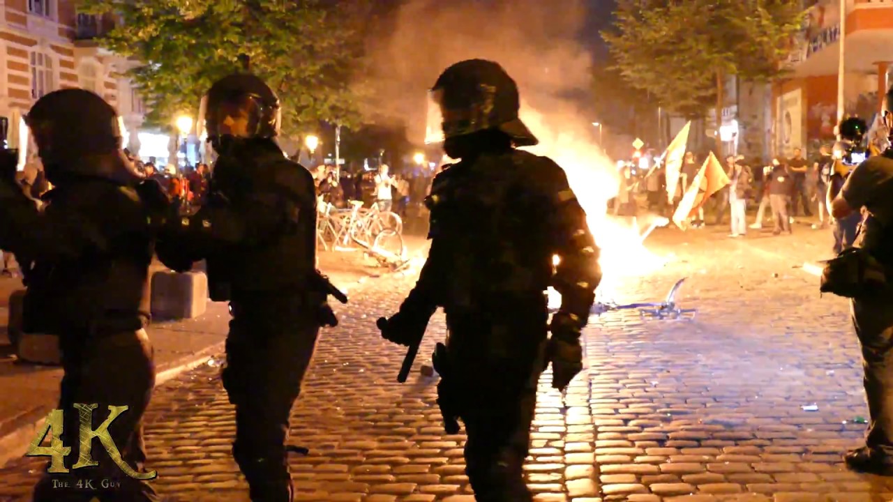Close view of riot police at night with fire in background - YouTube