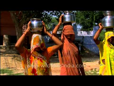 Village women carrying pots filled with water - YouTube