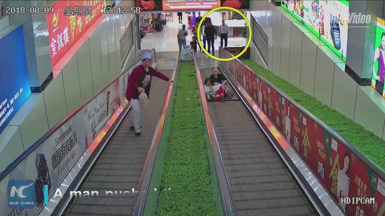Heroic moment! Passerby saves girl stuck in escalator in NW China - YouTube
