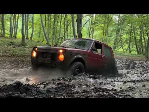 Lada Niva 4×4 offroad in the forest. Lada Niva 4×4 in the mud