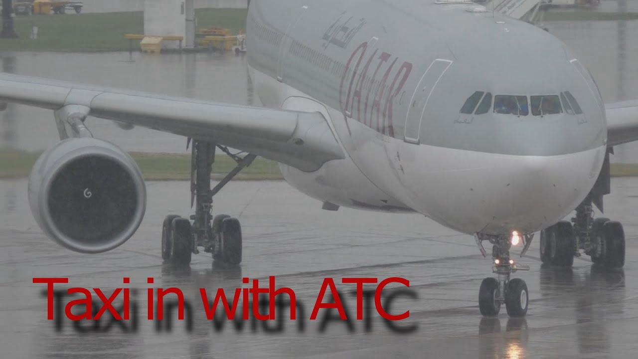 Qatar airways Taxiing in manchester airport terminal 2 rain ATC A7-AED ...