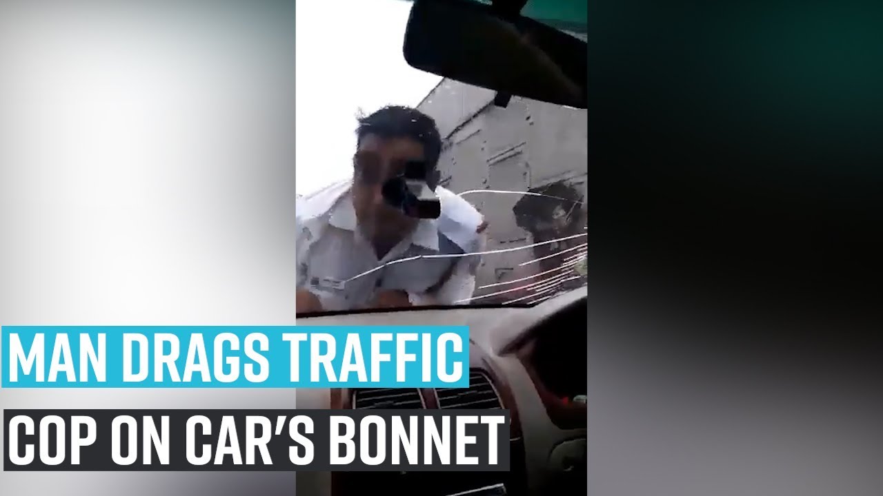 Man drags traffic cop on car's bonnet - YouTube