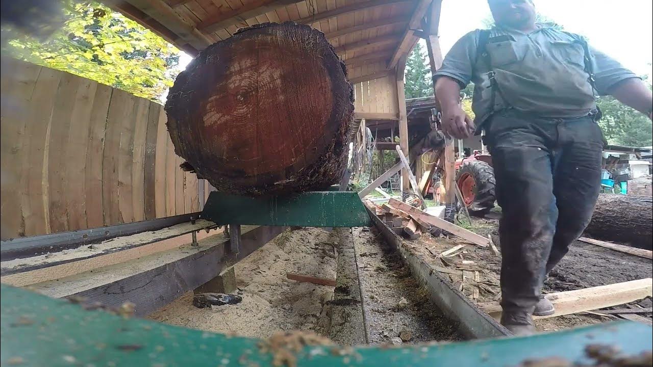 Unloading some large logs and loading on sawmill with a winch - YouTube