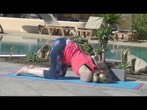 Yoga lesson by the pool