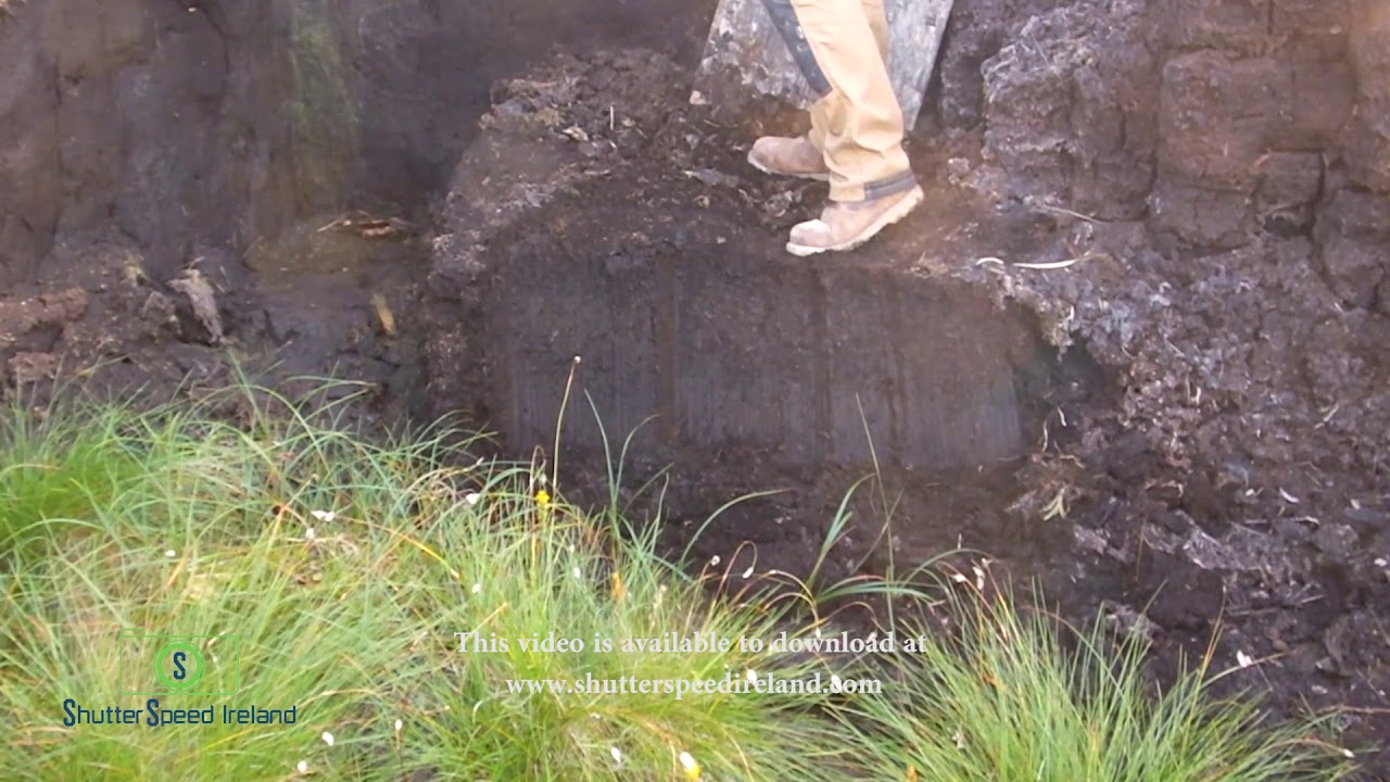 Turf cutting peat at a bog in Ireland - YouTube