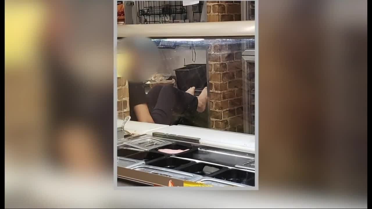 Subway worker caught on camera placing bare feet near food prep area ...
