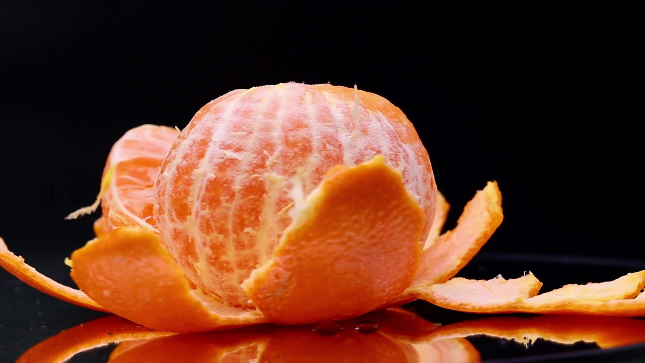 Close-up rotation of fresh orange rotating in black background - YouTube