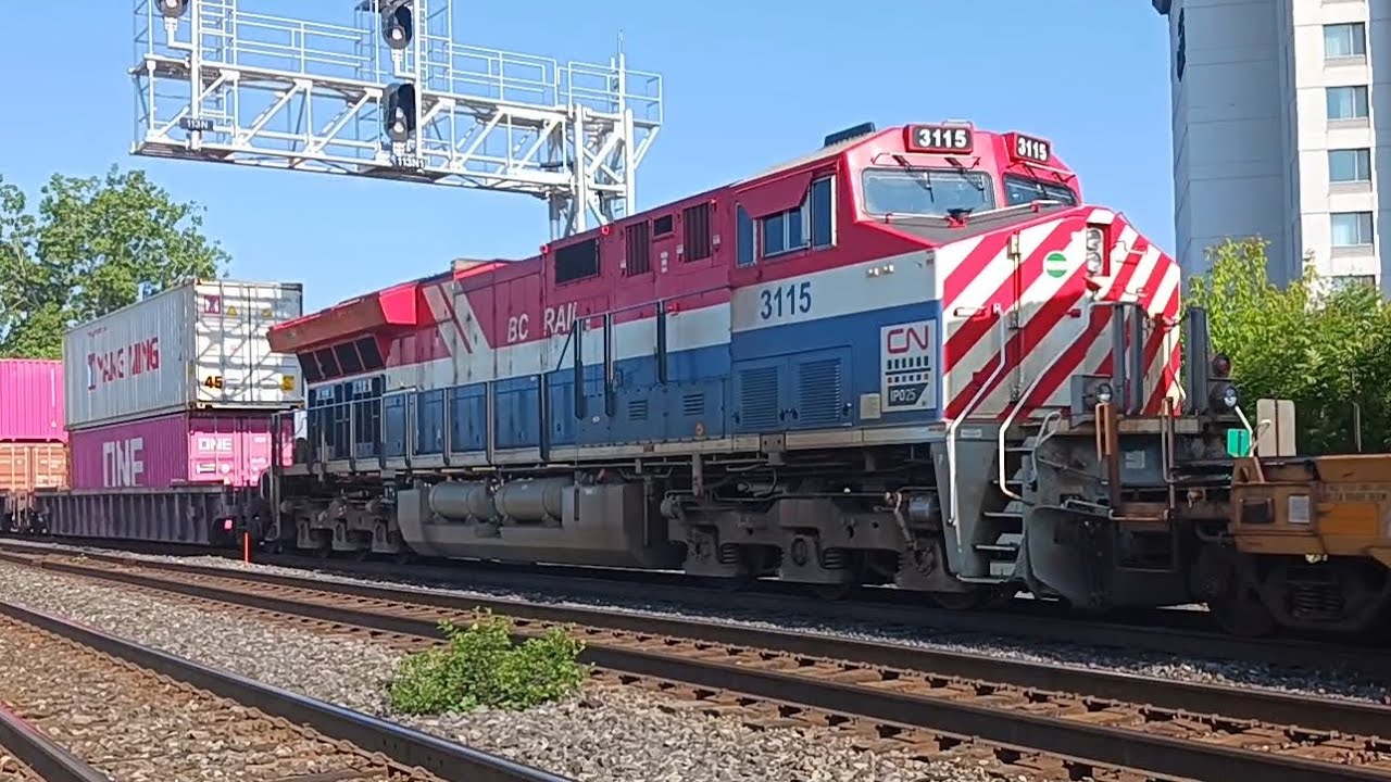 CN Z121 passing Gare Dorval, Qc with the "BCRail" heritage unit and a ...