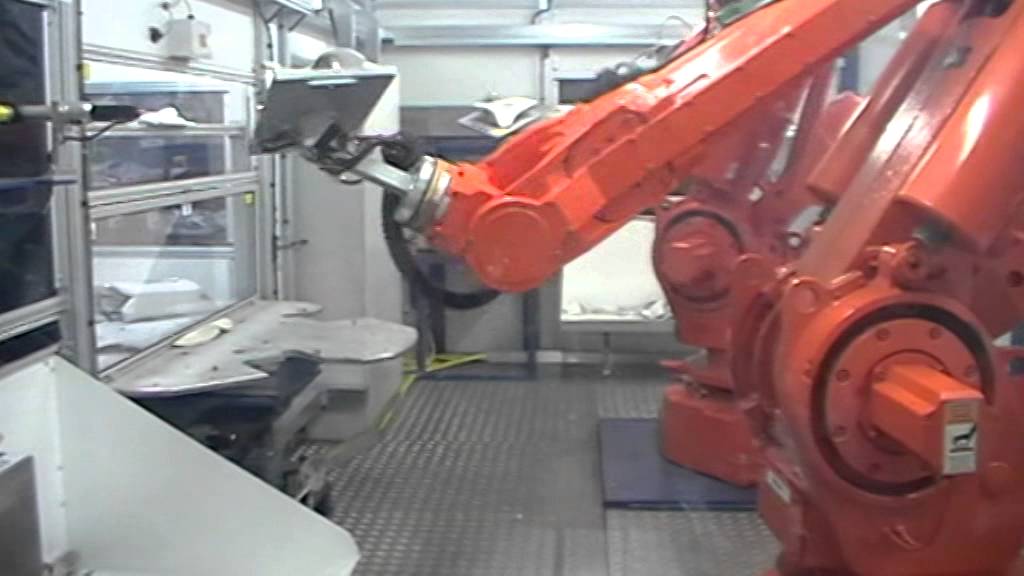 Automotive interior trim laser cutting robot cell - 2 lasers & 2 robots ...