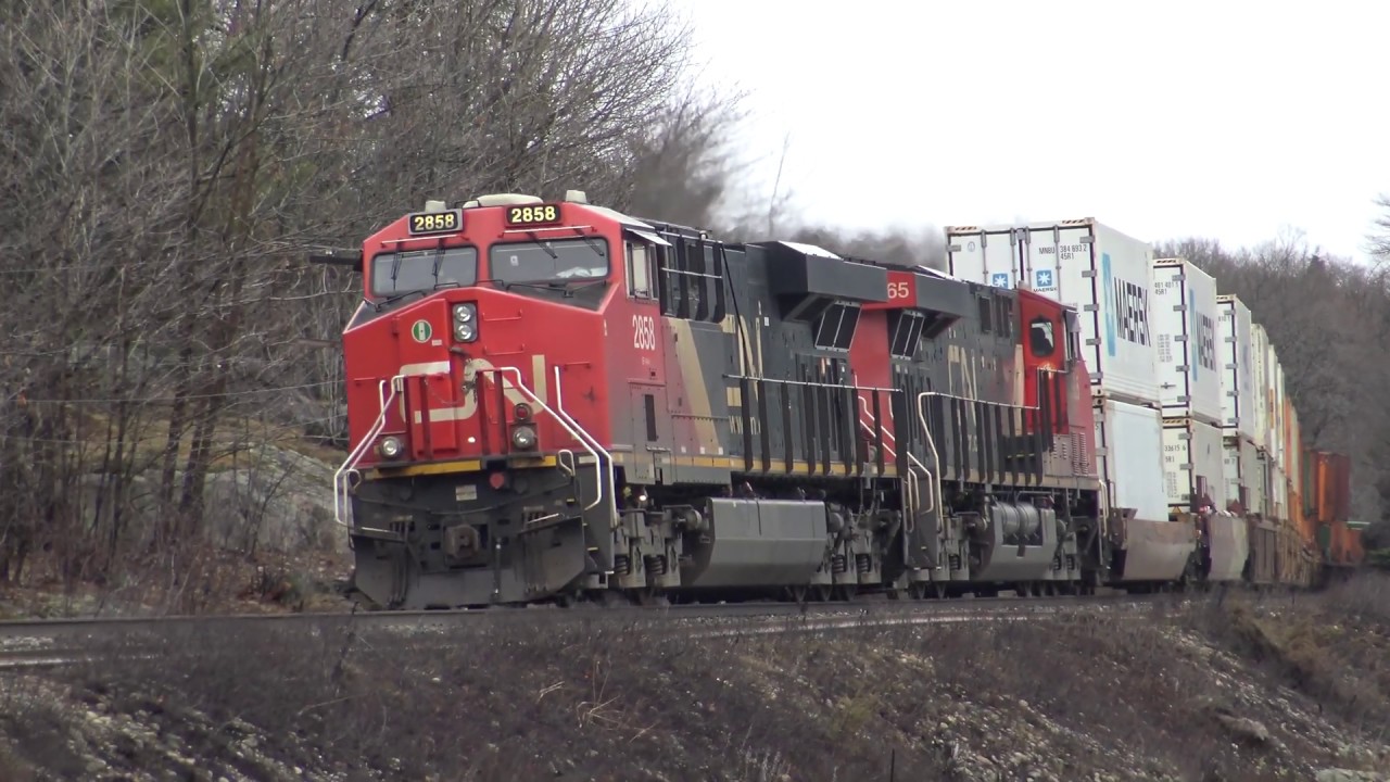 [4K!] CN train 101 crawls north following right behind another train ...