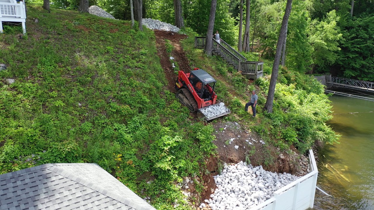 Kubota Hauling Rip Rap on steep lakeside hill, video 1 of 3 - YouTube