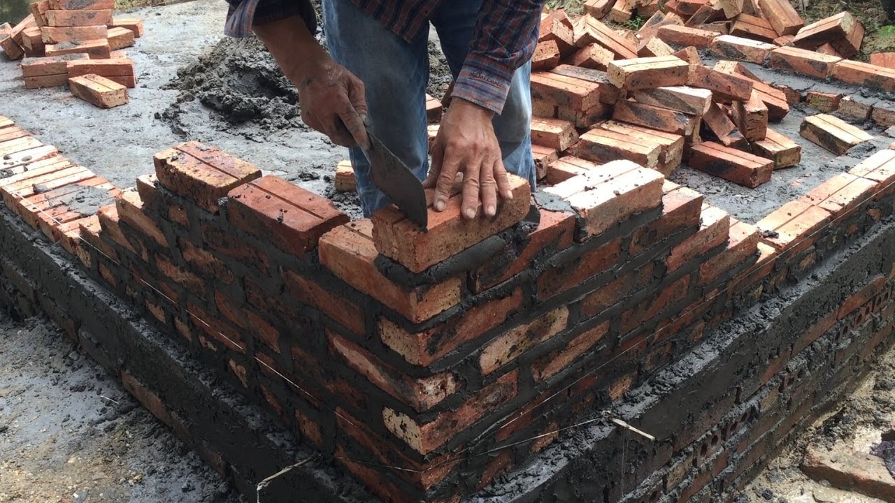 Smart Construction Worker Laying A Brick The Accurate - Building Brick ...