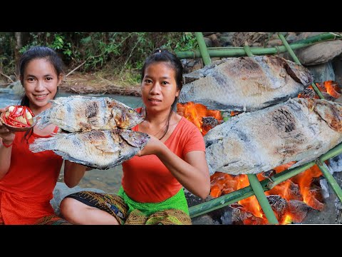 Two girls Cooking two Tilapia fish at river | grilled Tilapia fish and eating | primitive life KH