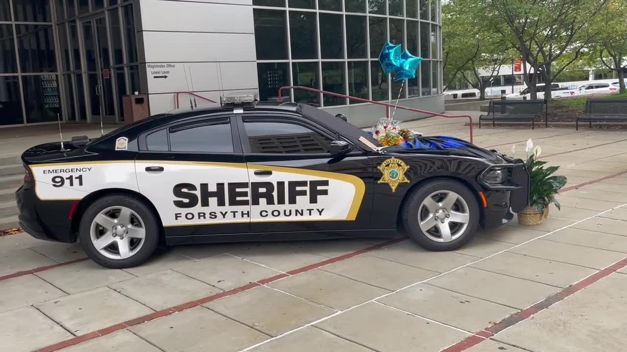 The Forsyth County Sheriff's Office parks a patrol car in front of the ...