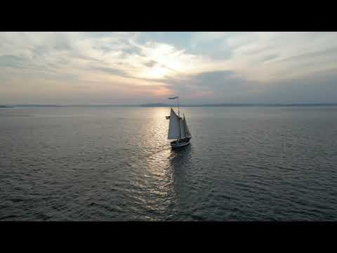 Bay Lady Sailing into the sunset over Bainbridge Island - Aerial 4k footage of the Puget Sound