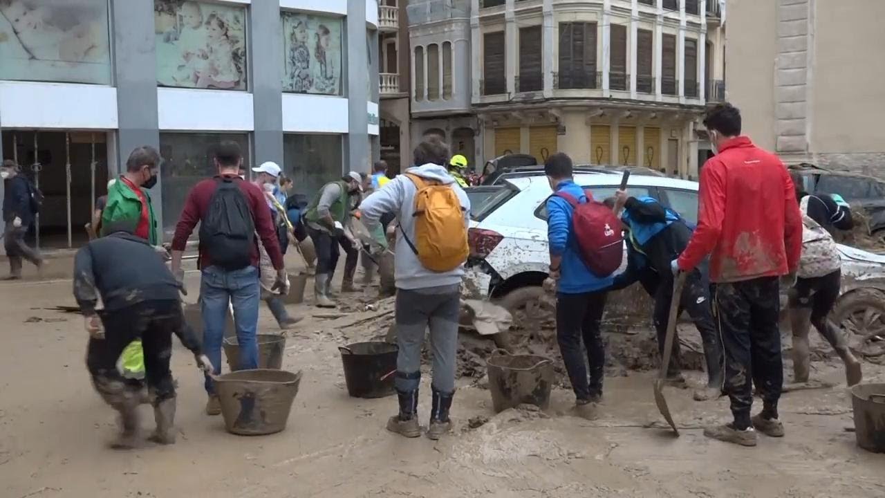 Volunteers with shovels and buckets join clean-up efforts in Valencia ...