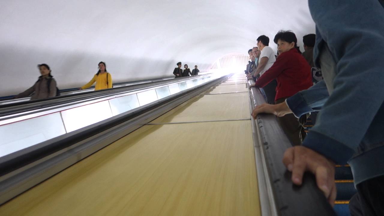 Taking the escalator up and out of a Pyongyang Metro station - YouTube