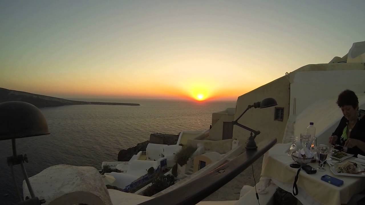 Beautiful Sunset Dinner in town of Oia on the Greek Island of Santorini ...