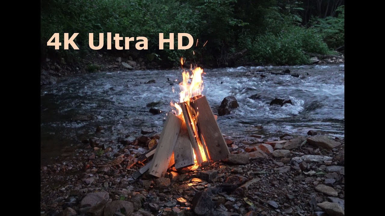 4K Campfire by the river. Relaxing sounds of the floating river, nature ...