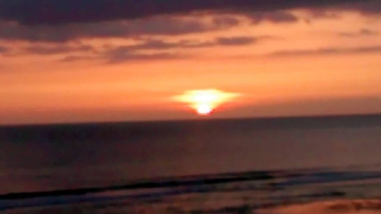 Sunset Sun going down over sea on west coast of France Normandy - YouTube
