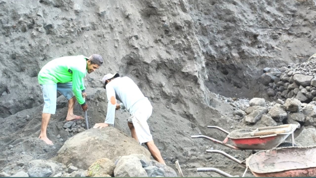 together to move large rocks from the sand slide - YouTube