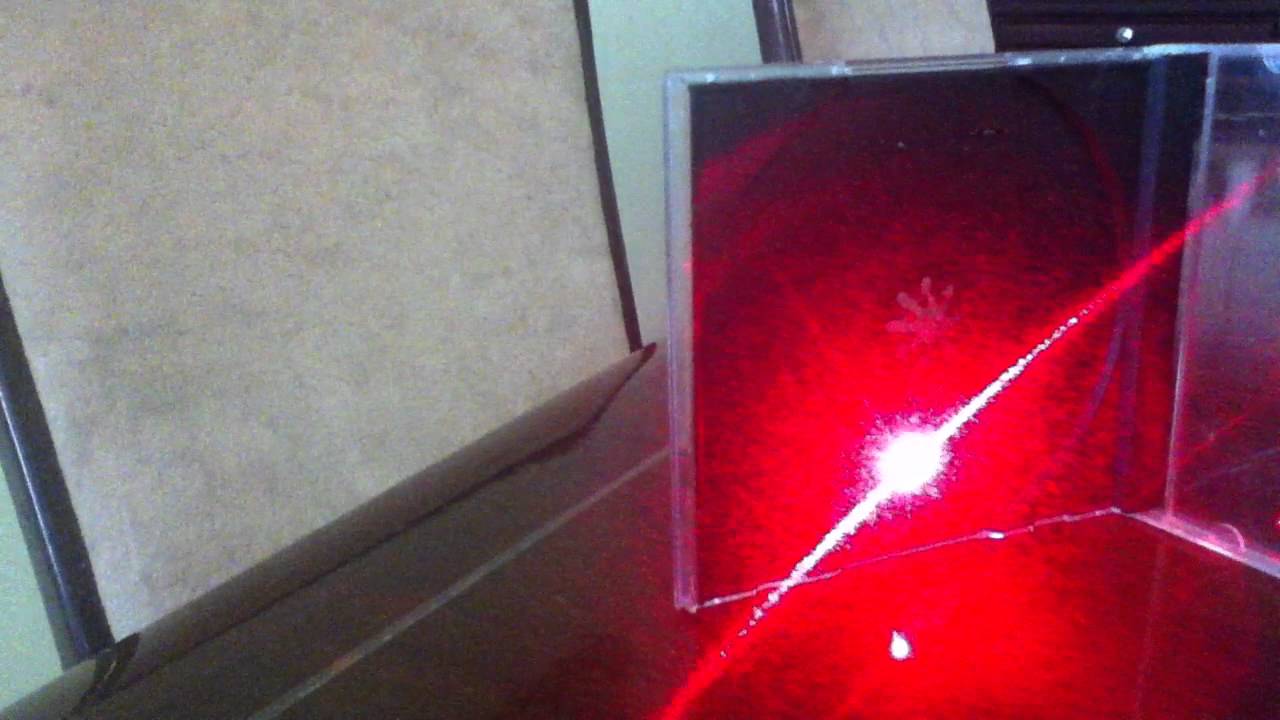 Red laser burning through a cd case - YouTube