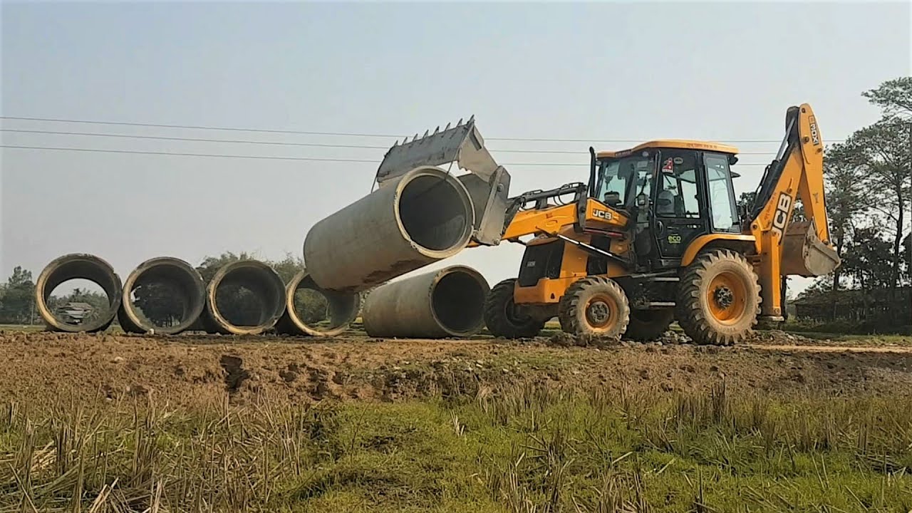 JCB Backhoe Machine Lifting Heavy Culvert Pipe and Installing in Drain ...