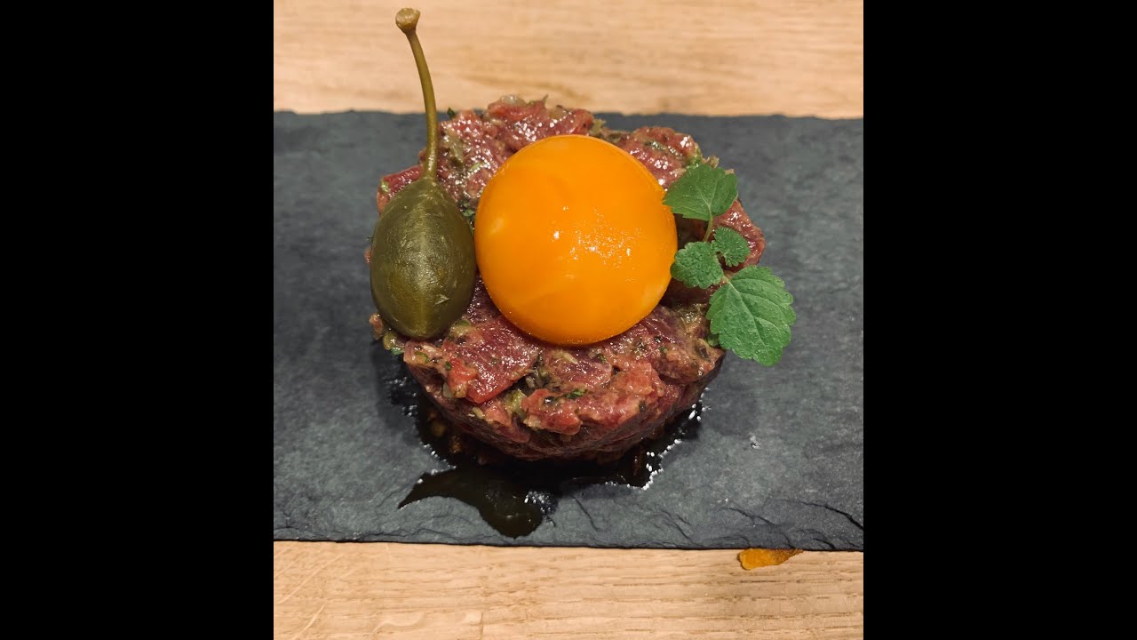 Truffle beef tartare served on a sweet potato rosti topped with a cured ...