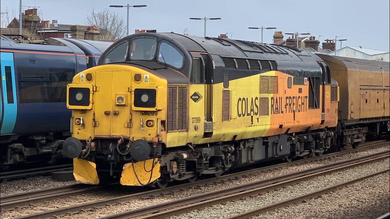 37099 “Merl Evans” on a Colas UTU test train and 37418 with “Caroline ...