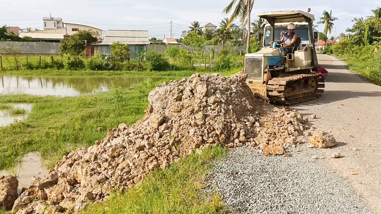 Excellent skillful dozer preparing dam pushing soils to deep water ...