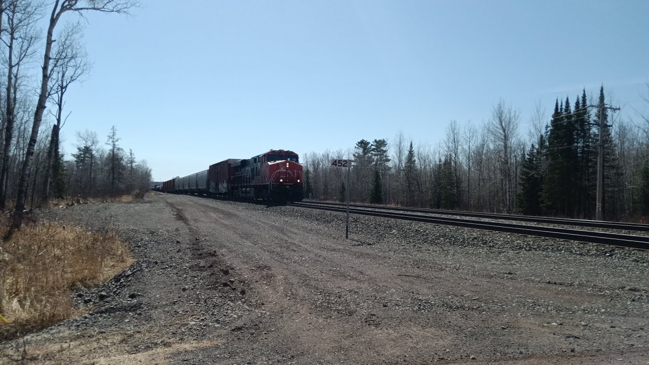 Fast CN mix freight train with a DPU and stops at the end of the video ...