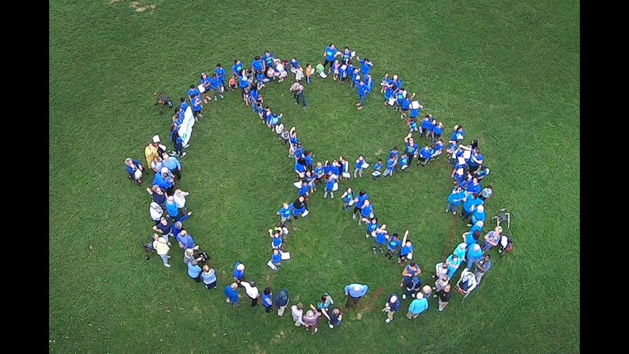 Human Peace symbol formed by kids roughly from 1 to 92 - YouTube
