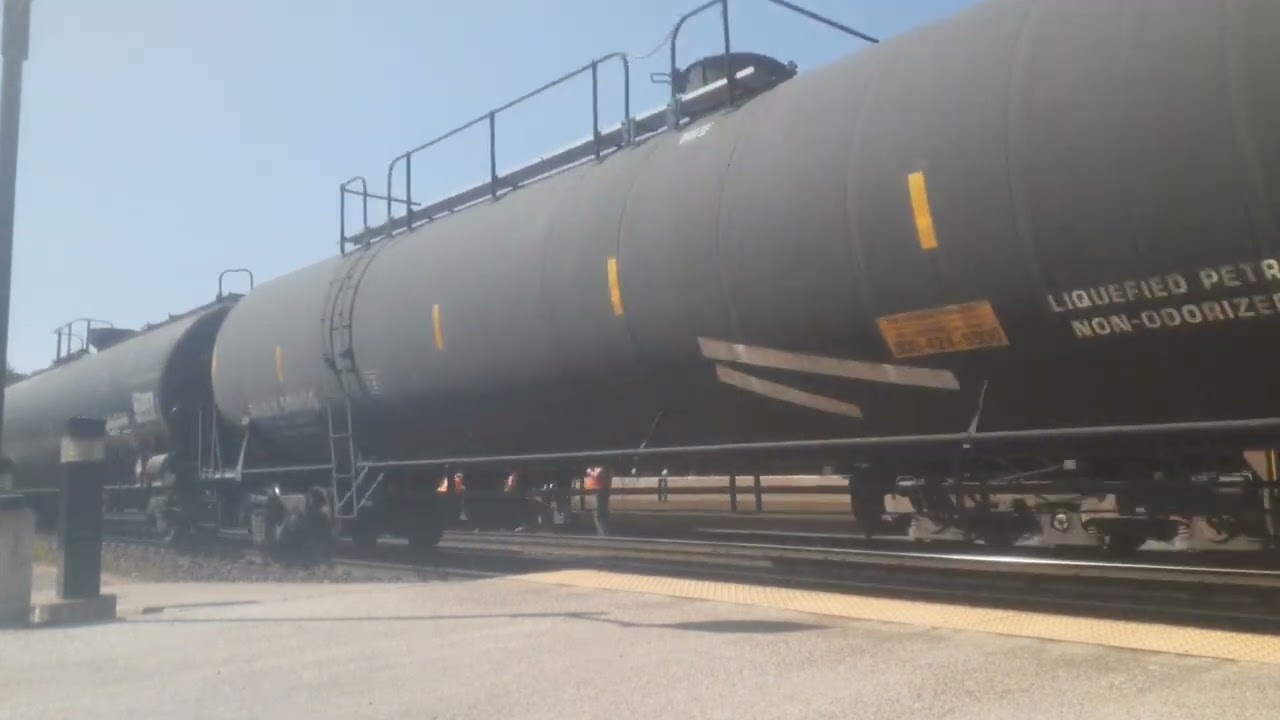 BNSF Manifest Train passes as the lift crew resets the locomotive after ...