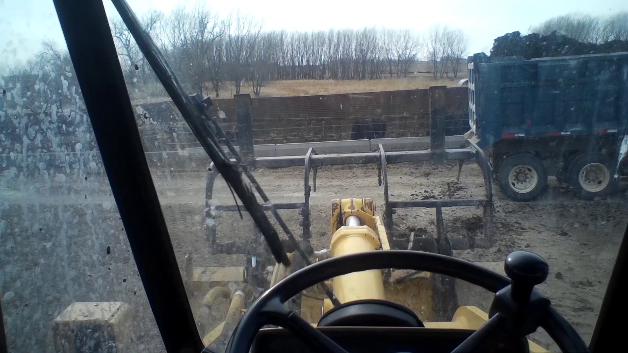 Hauling manure to stockpile with 26 foot end dump - YouTube