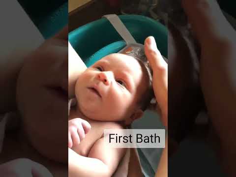 First Bath. Mommy gently washing newborn baby Emily's head for the ...