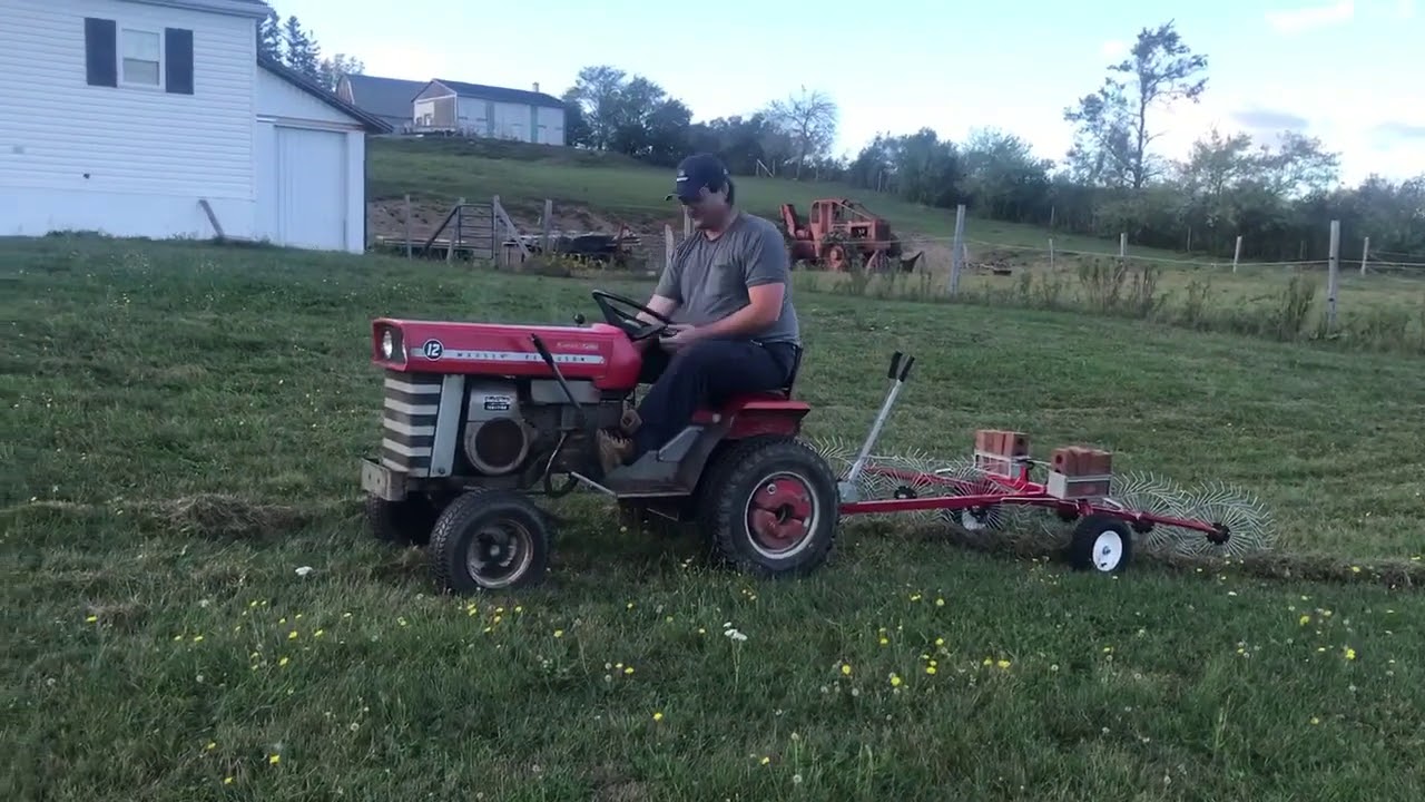 Mf12 garden tractor with estate rake - YouTube