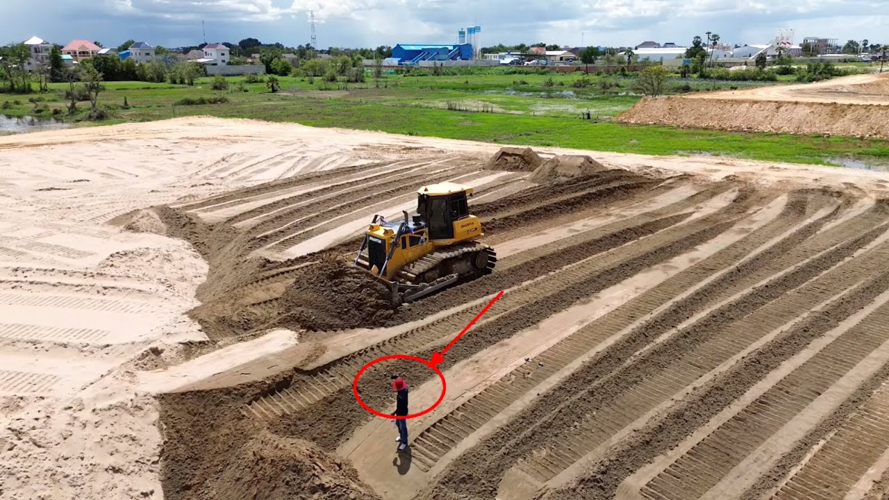 Talented skill Operator bulldozer SHANTUI spreading sand by filling it ...